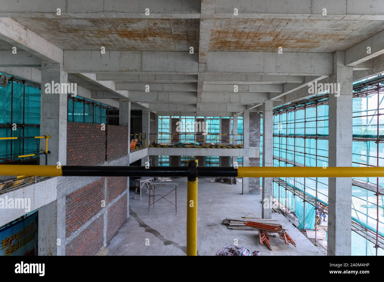 inside of an unfinshed building with protection scaffolding and netting ...