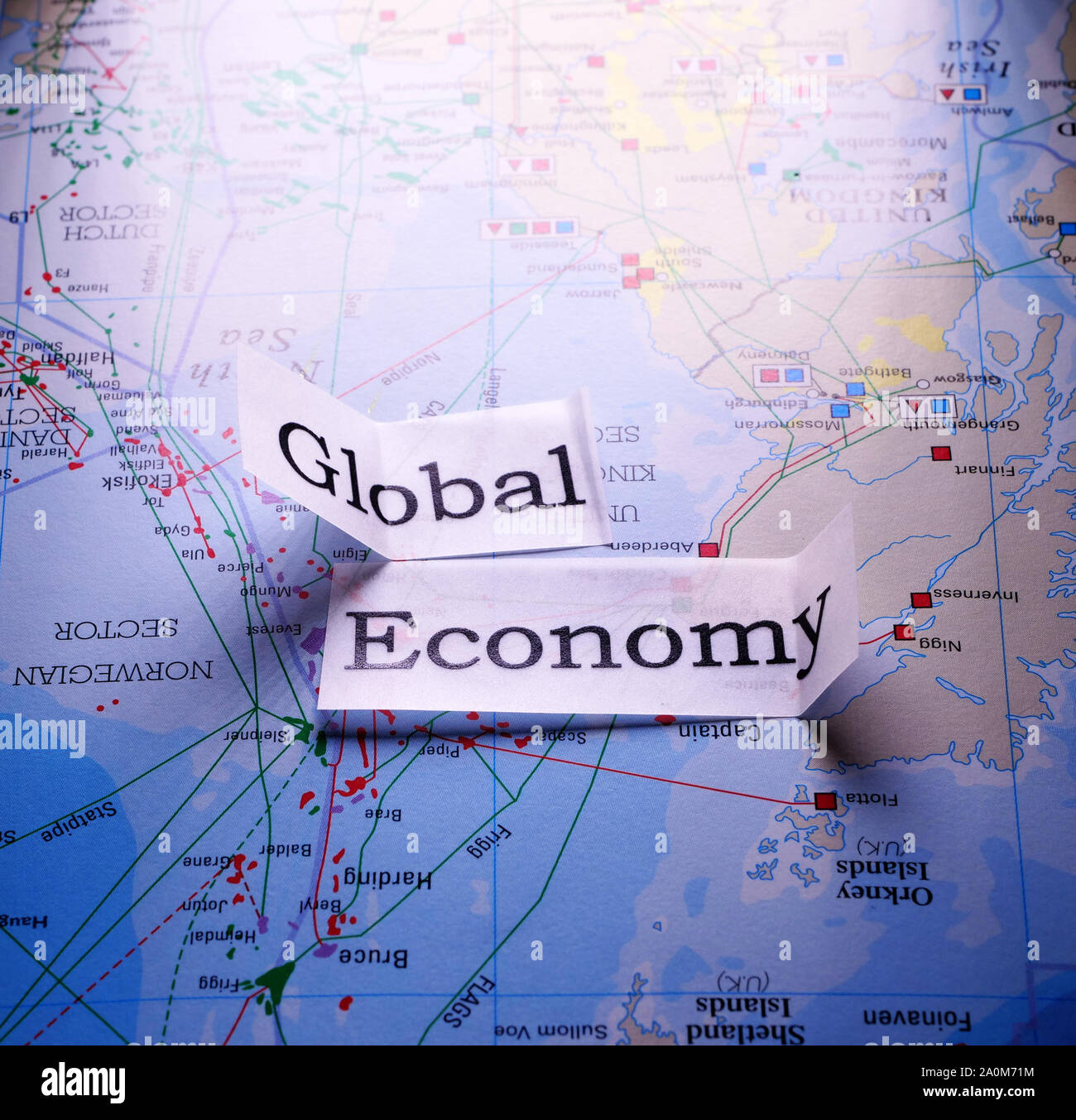 Close up of global economy tag on a world map Stock Photo - Alamy