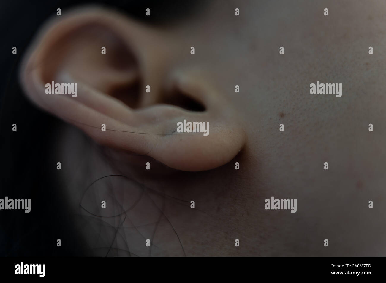 Close up of human head with female ear. Listening or deafness concept ...