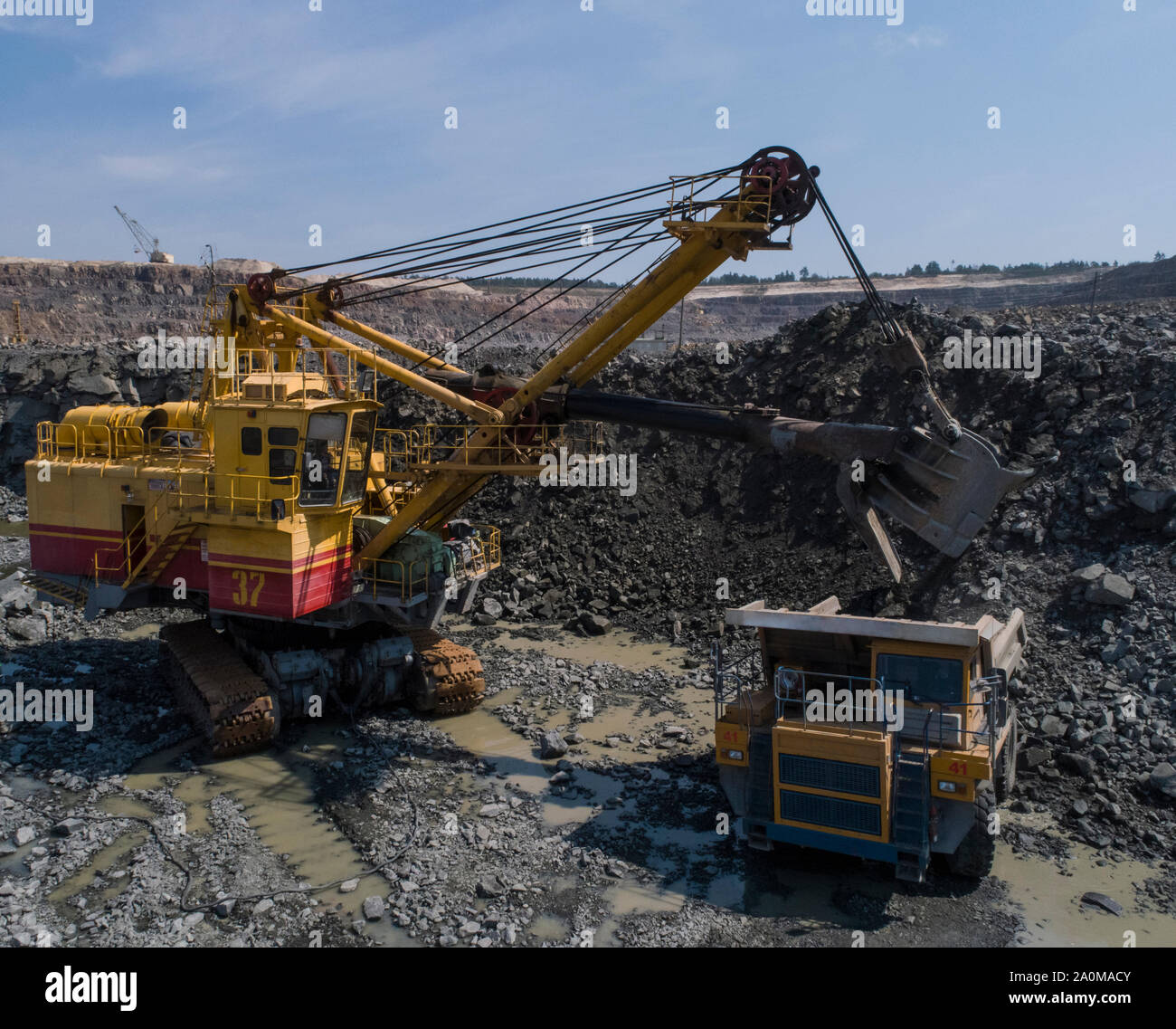 Huge industrial dump truck in a stone quarry loaded transporting marble ...