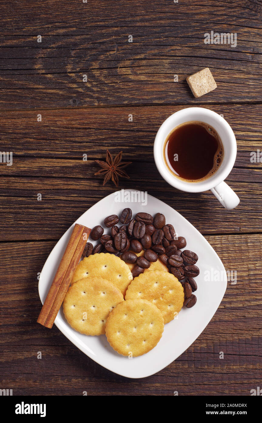 Coffee cup and tasty crackers on wooden table, top view Stock Photo - Alamy