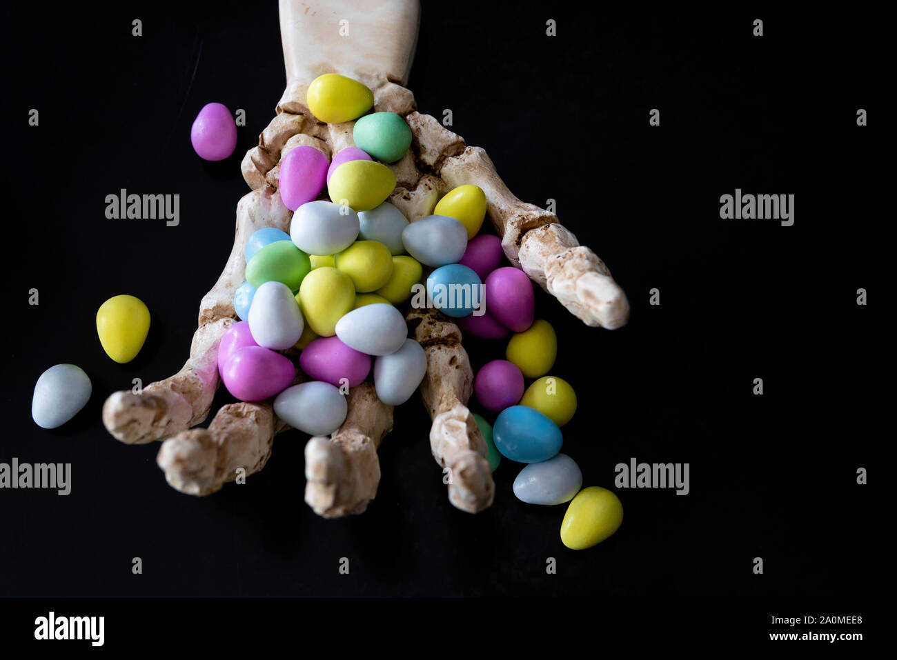Skeleton hands and Claws holdin Halloween Candy Stock Photo - Alamy