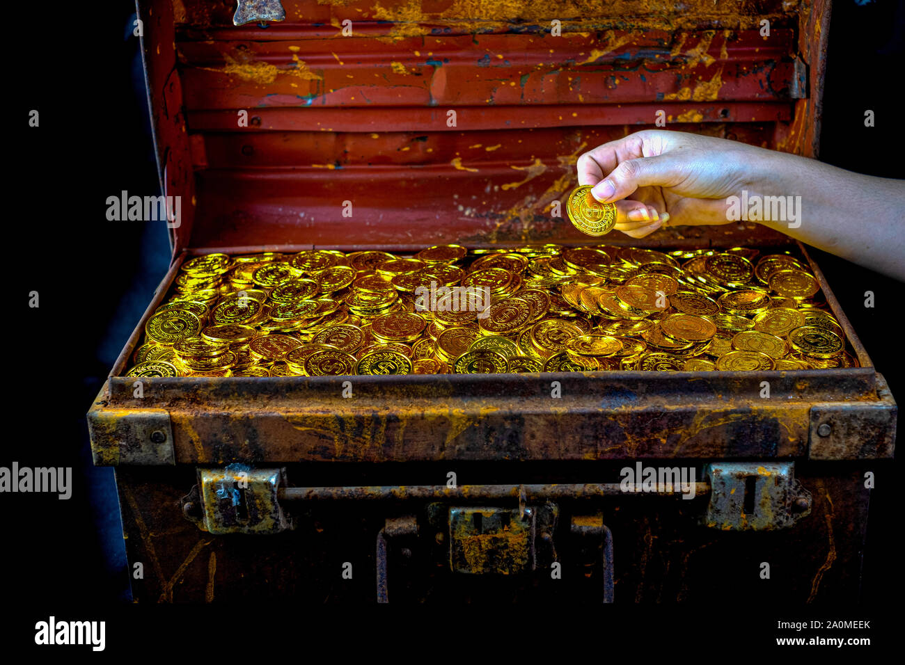 Lots of stacking Gold Coin in lady hand and treasure chest at black ...