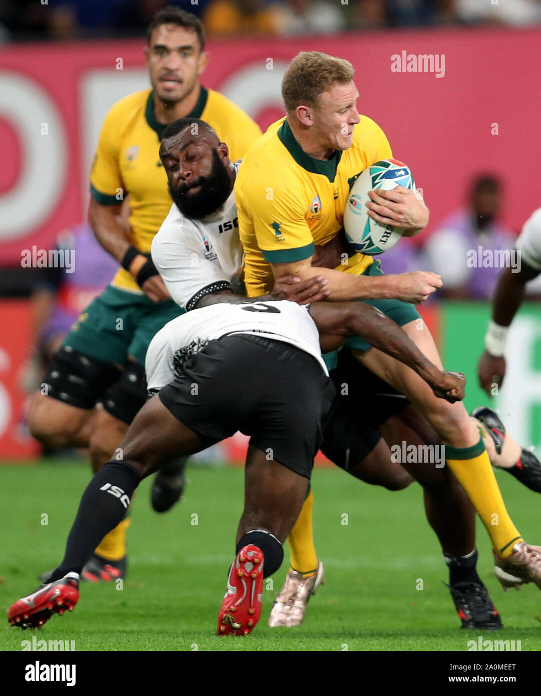 Australia's Reece Hodge (right) is tackled by Fiji's Frank Lomani ...