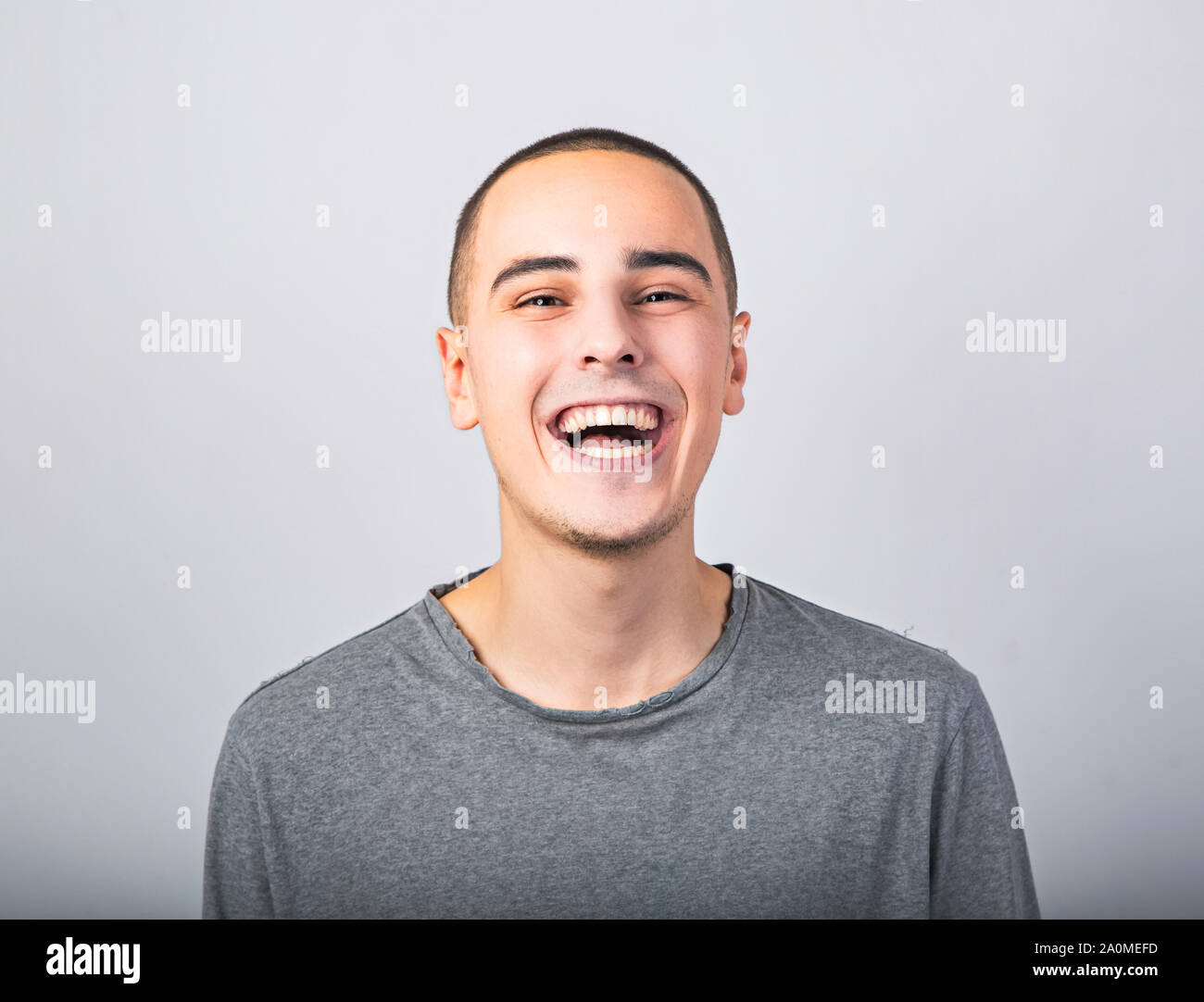 Happy fun young man laughing with wide opened mouth in casual clothing ...