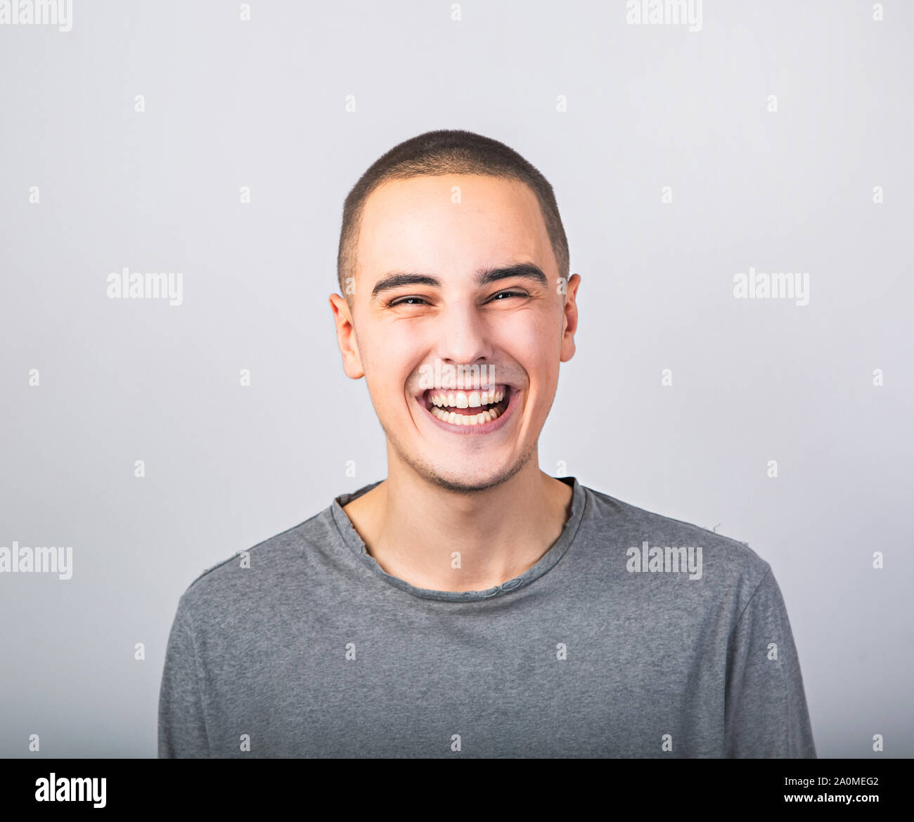 Happy fun young man laughing with wide opened mouth in casual clothing ...