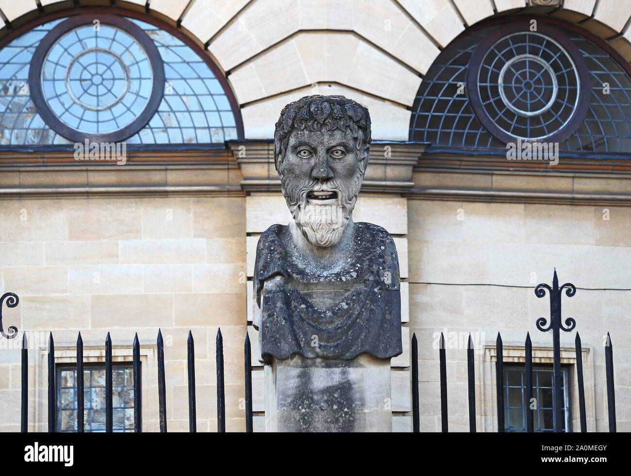 a carved head on a pillar outside the Sheldonian Theatre, Oxford called ...