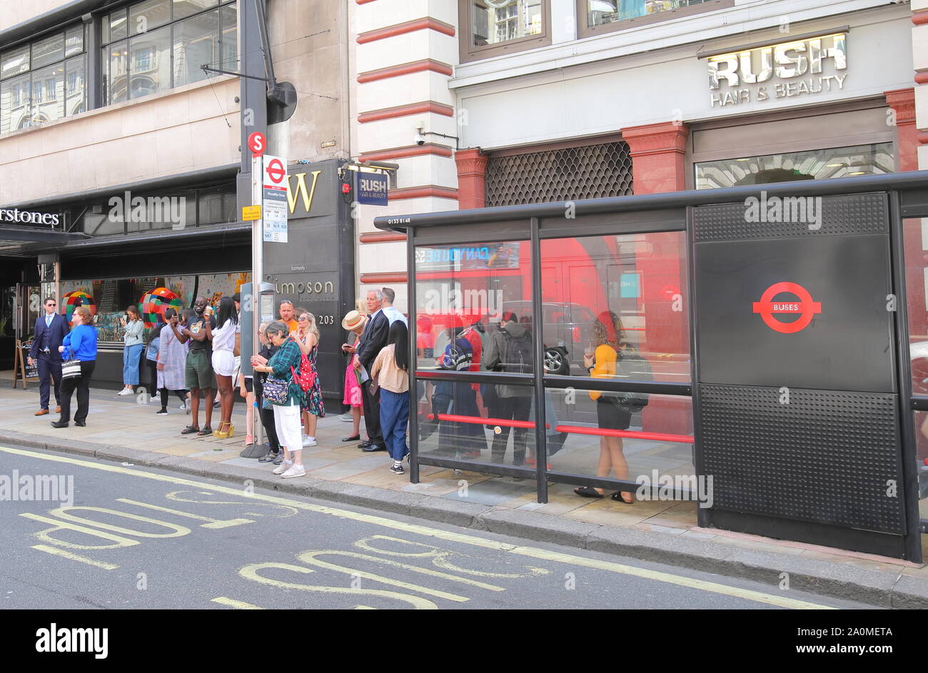 People waiting bus stop london hi-res stock photography and images - Alamy