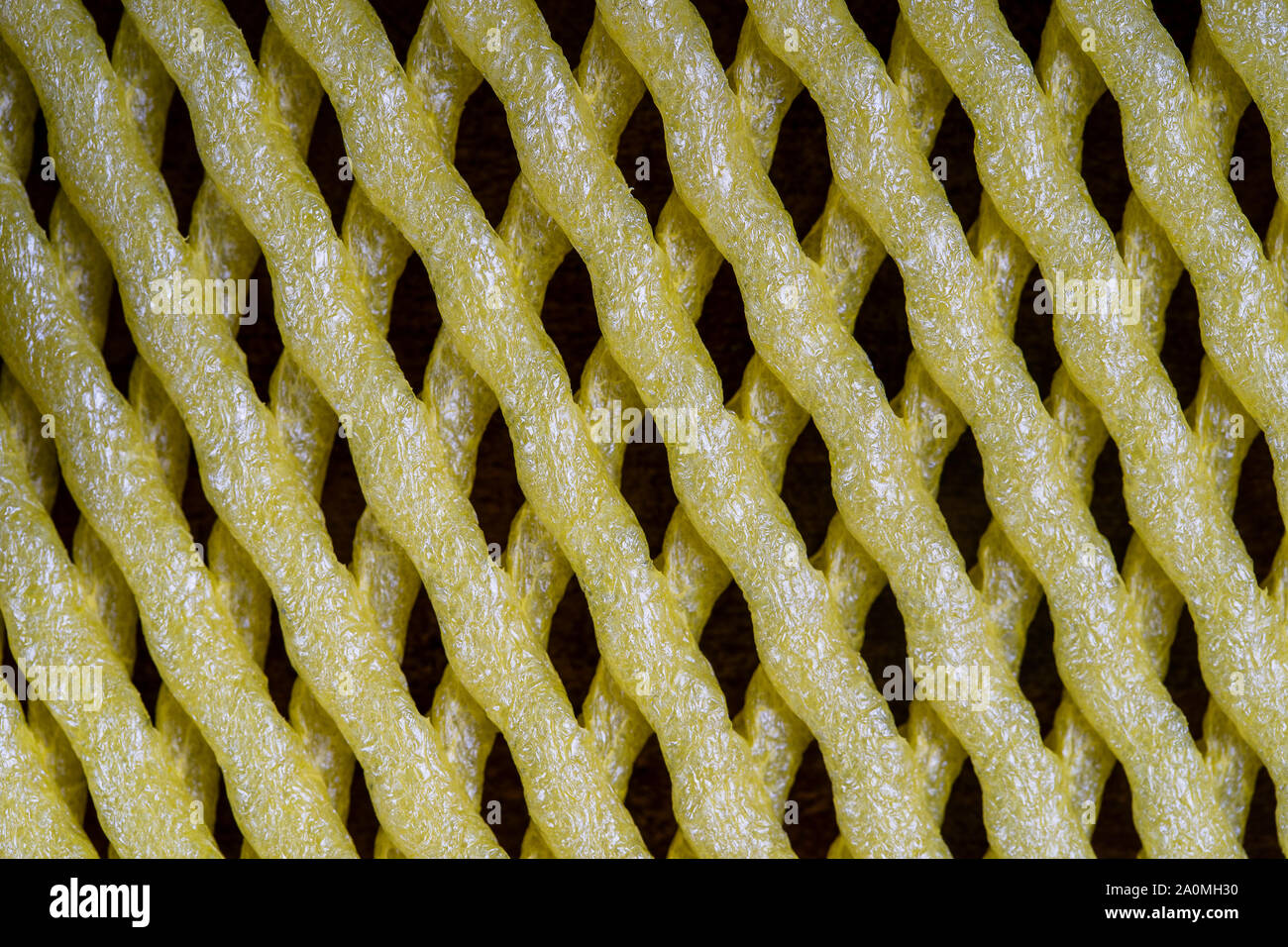 Abstract background of yellow plastic mesh texture for fruit storage ...