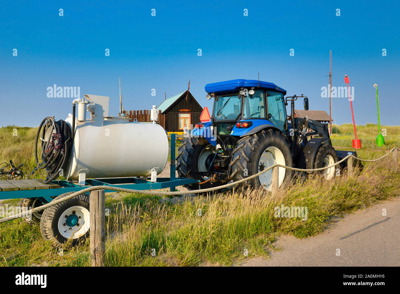 Texel, Netherlands - August 2019: Tractor with tank spreader for ...