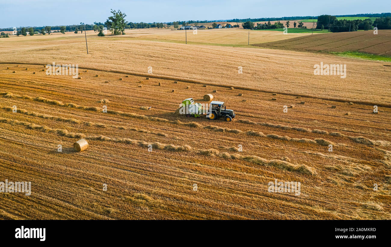Aerial view of machines for collecting and pressing hay Stock Photo - Alamy