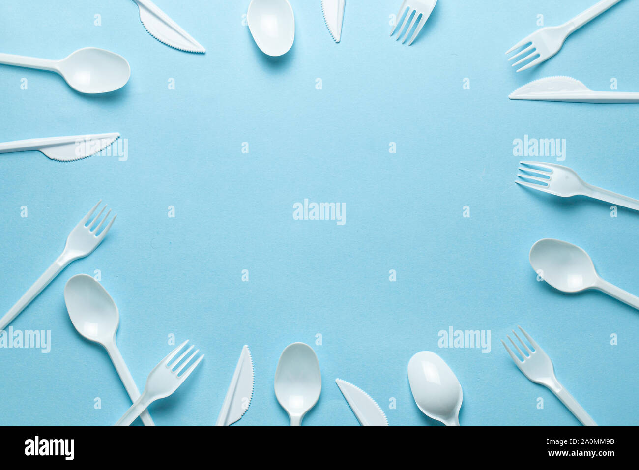 Plastic cutlery, forks, spoons and knives. Pollution of the environment ...
