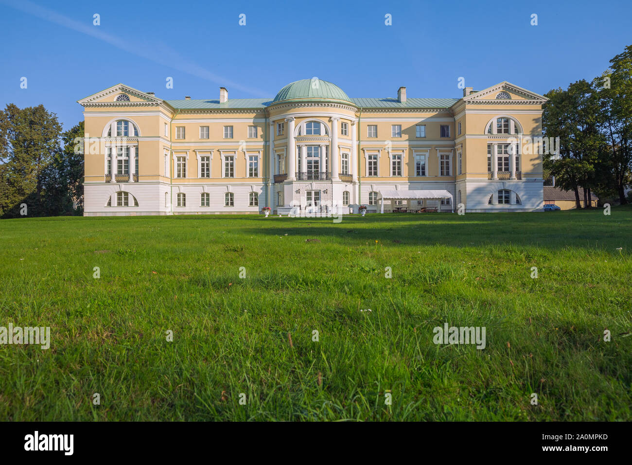 City Mezotne, Latvia Republic. Park with old castle. Trees and green ...