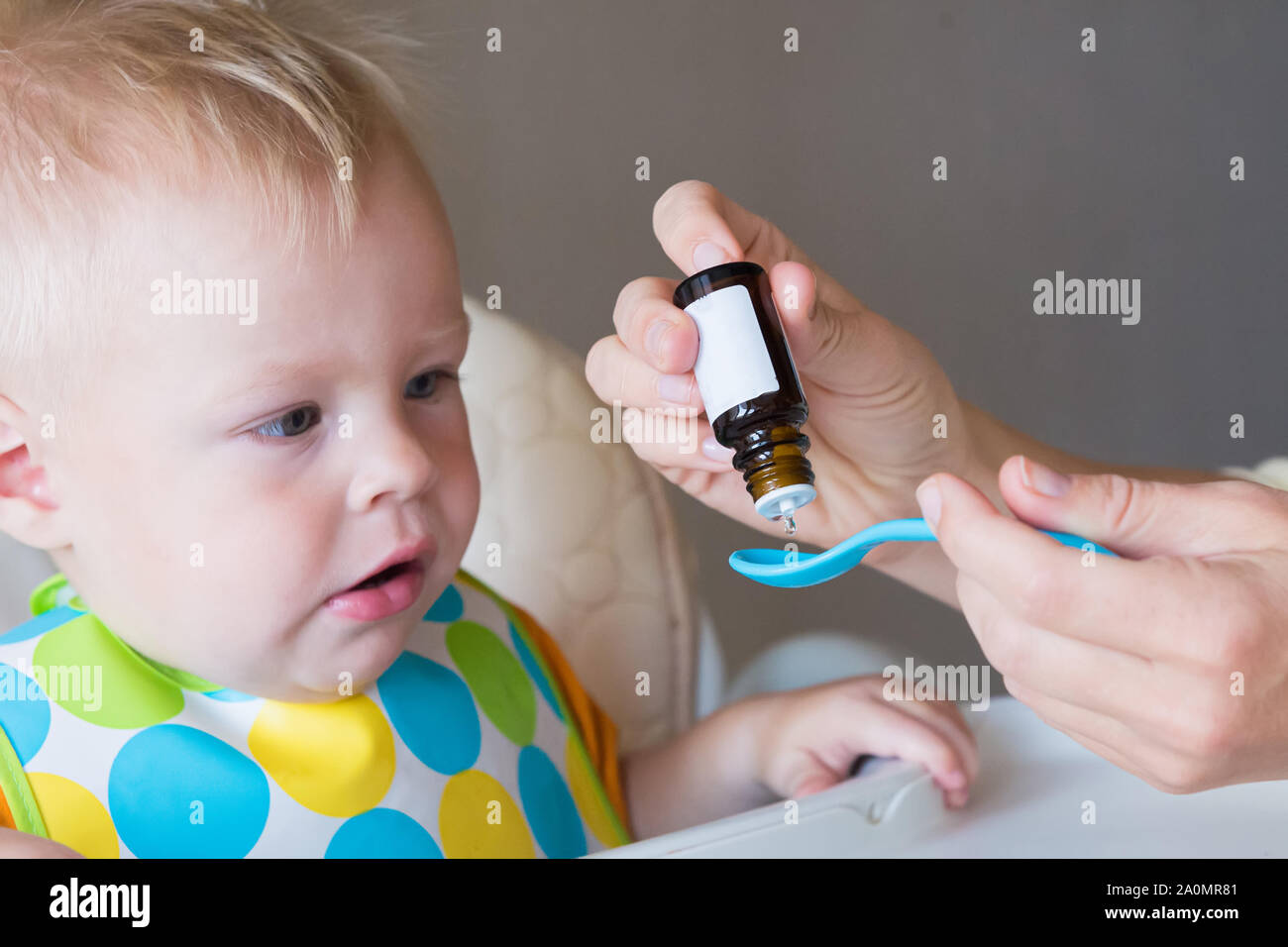 Mother giving medicine son treatment hi-res stock photography and ...