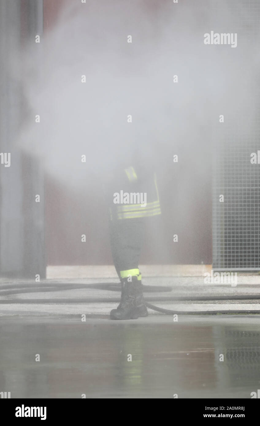 firefighter extinguishes the fire with the hydrant Stock Photo - Alamy