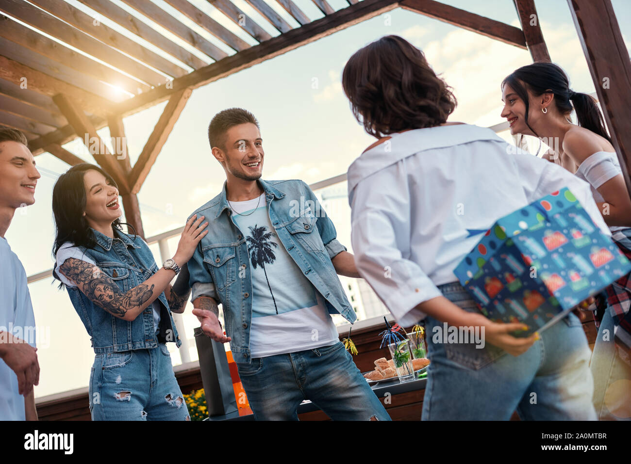 We have something special for you. Young woman is holding a gift box ...