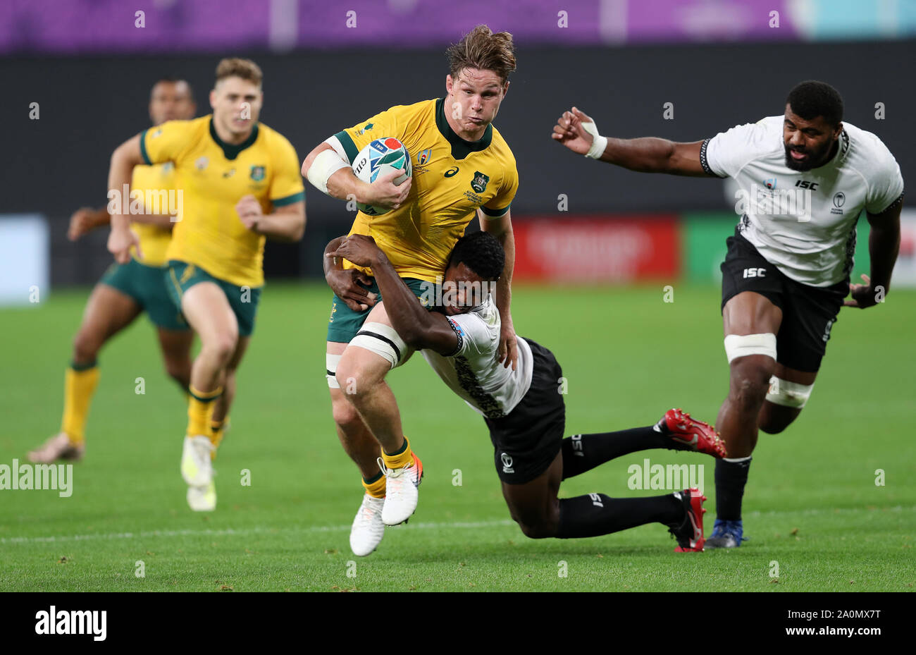 Australia's Michael Hooper (left) is tackled by Fiji's Frank Lomani ...