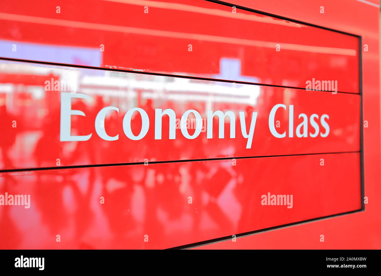 Economy class sign check in airport Stock Photo - Alamy