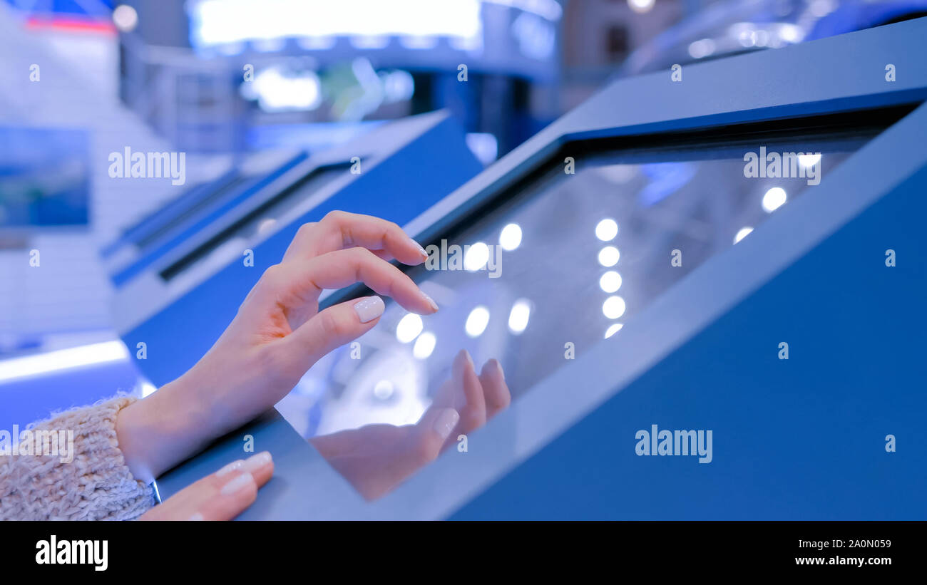 Woman using multimedia touchscreen display of interactive kiosk Stock ...