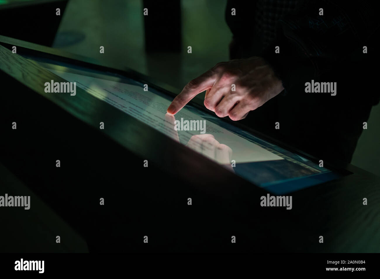 Man hand using multimedia touchscreen display of interactive kiosk at ...