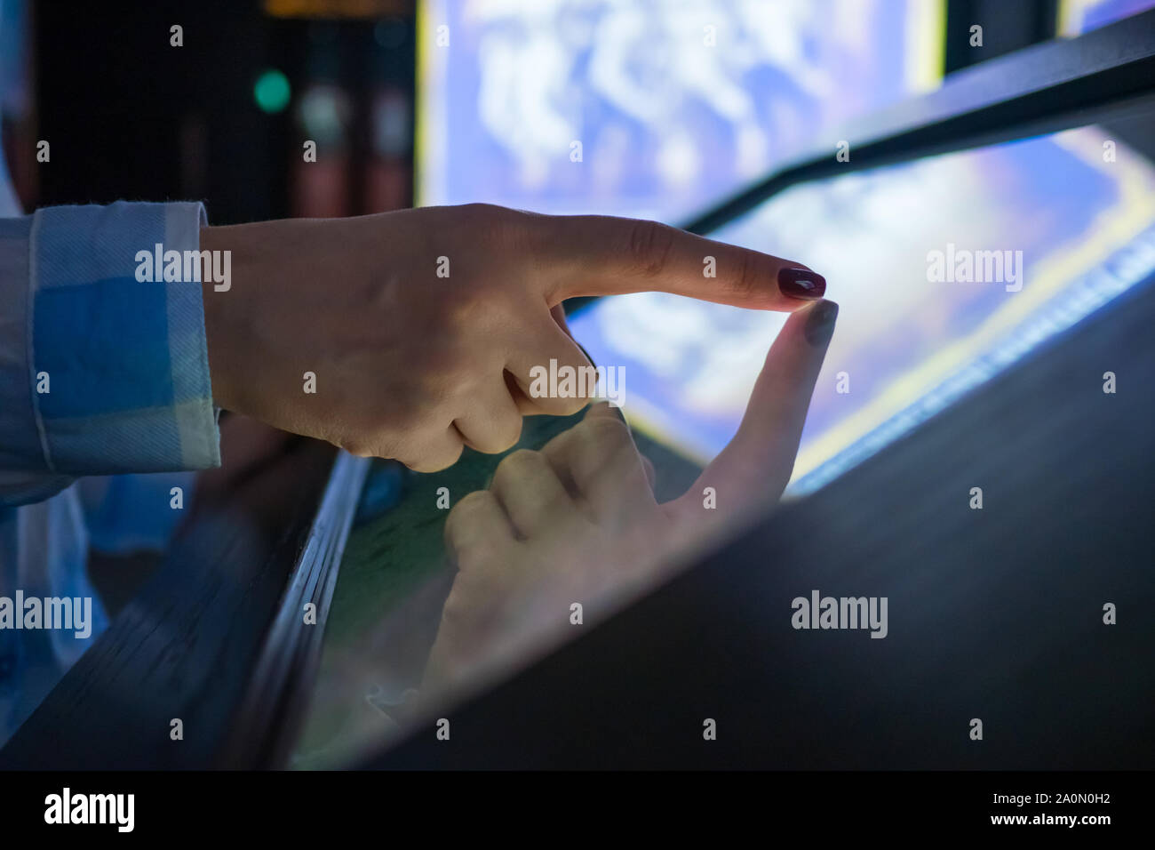 Woman using interactive touchscreen display at modern museum or ...