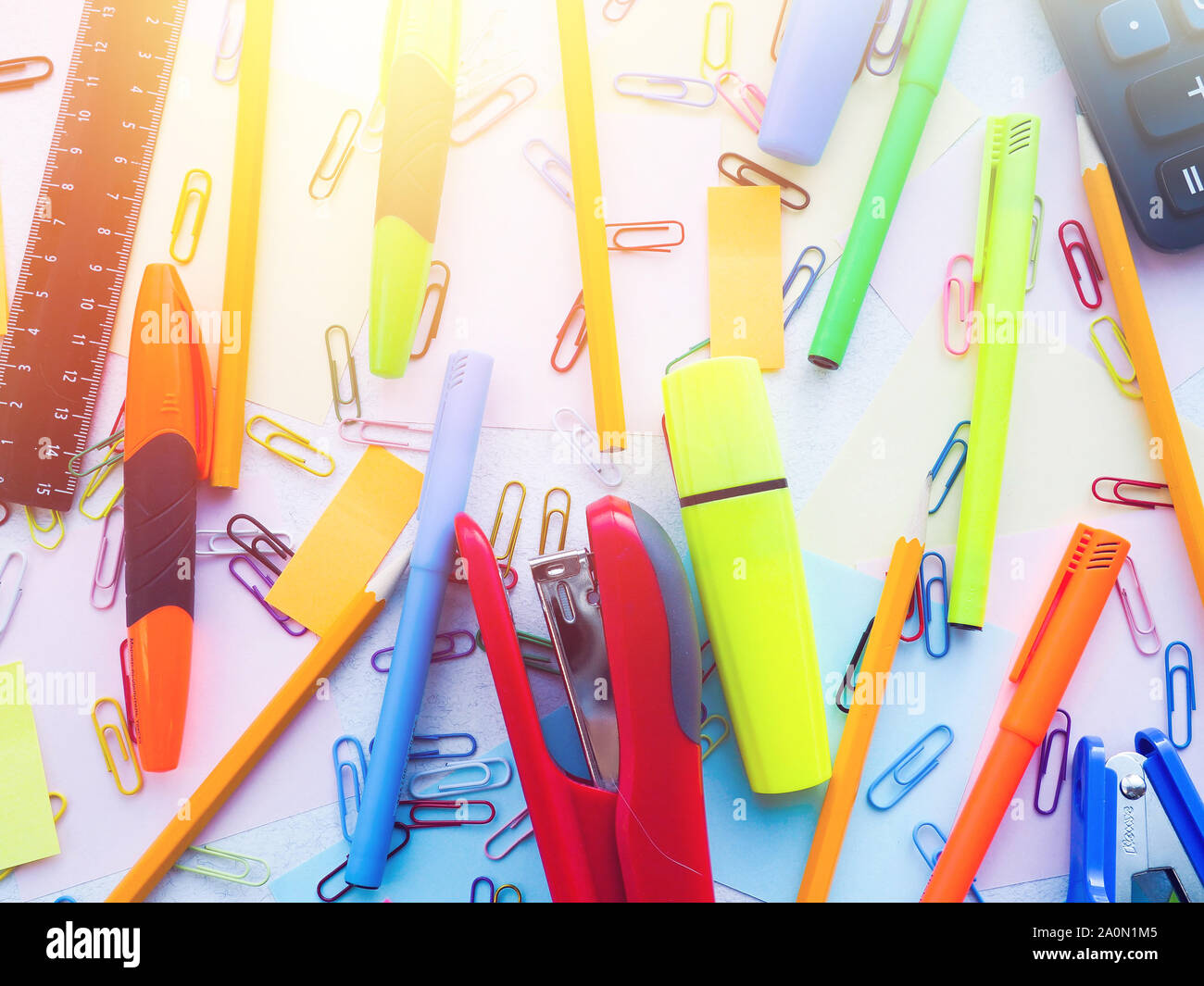 stationery stapler, paper clips, notes, pens and pencils on the table ...