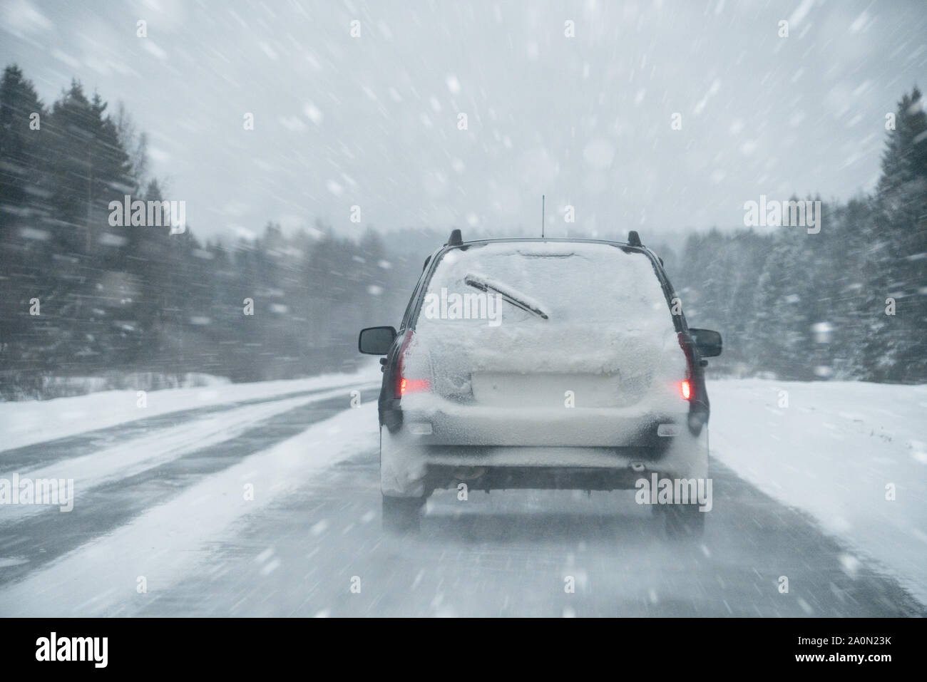 The car is driving on a winter road in a blizzard Stock Photo - Alamy
