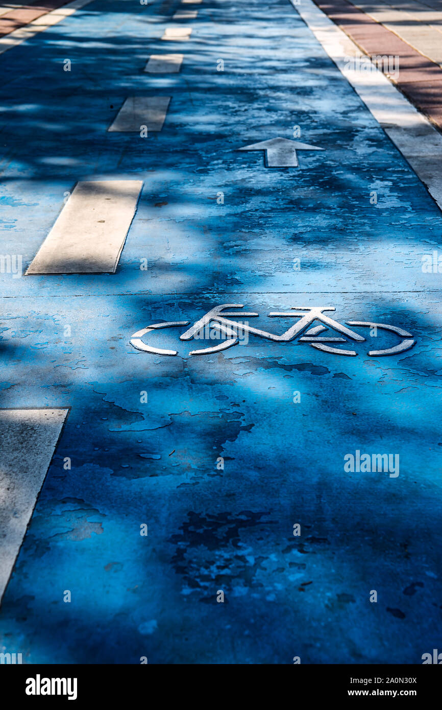 Bright blue bike path in a modern resort town for the convenience and ...