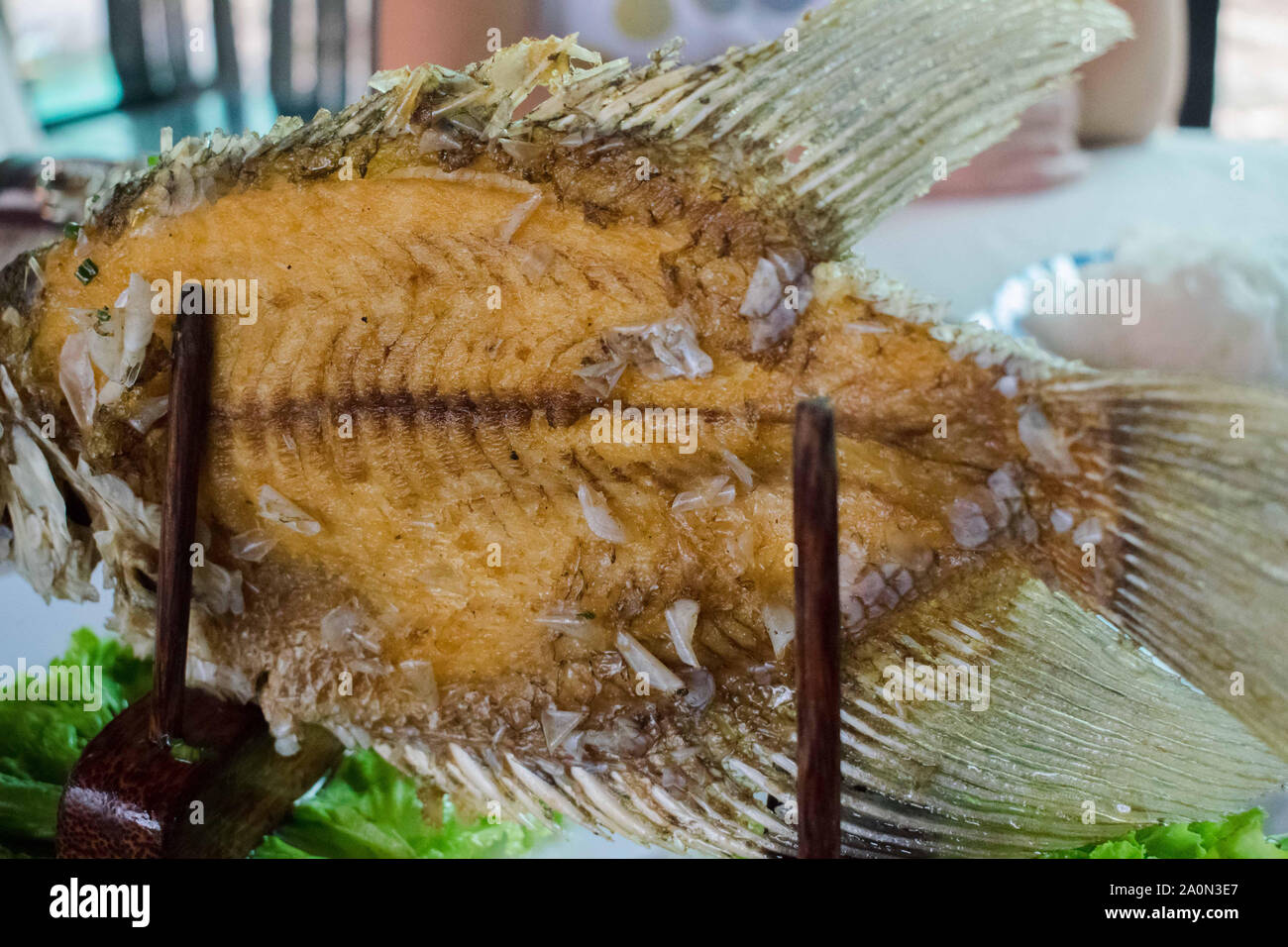 Fried large fish supported by wooden stand served at the mekong delta ...