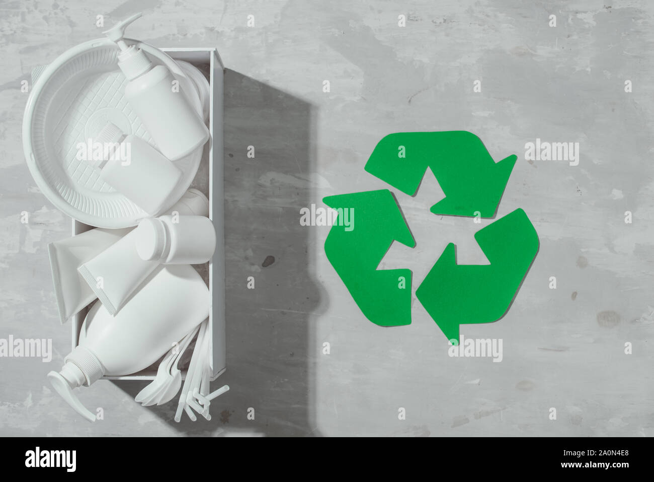 waste recycling eco symbol with garbage disposal on stone table ...