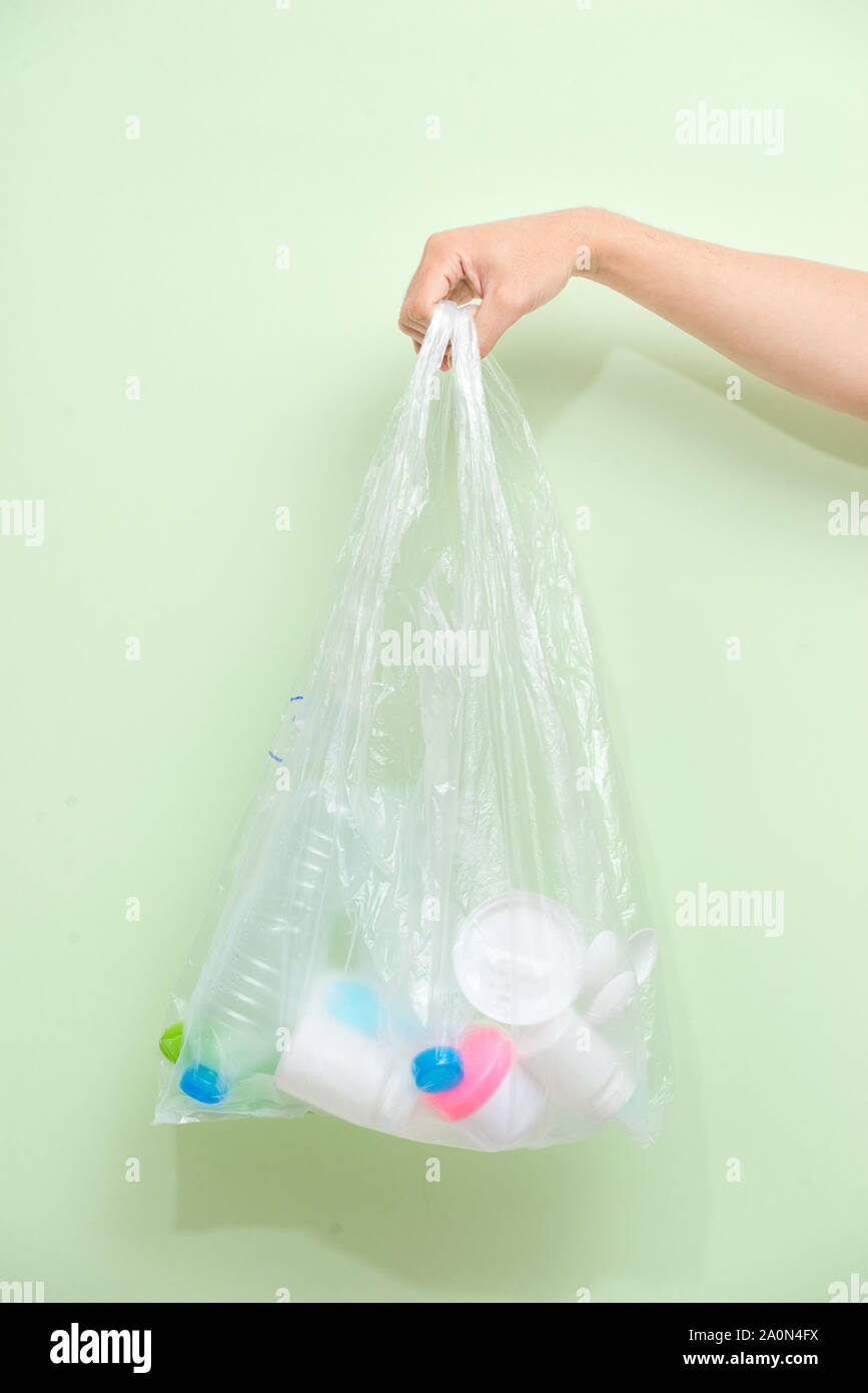 Female hand holding a waste bag isolated on white background Stock ...
