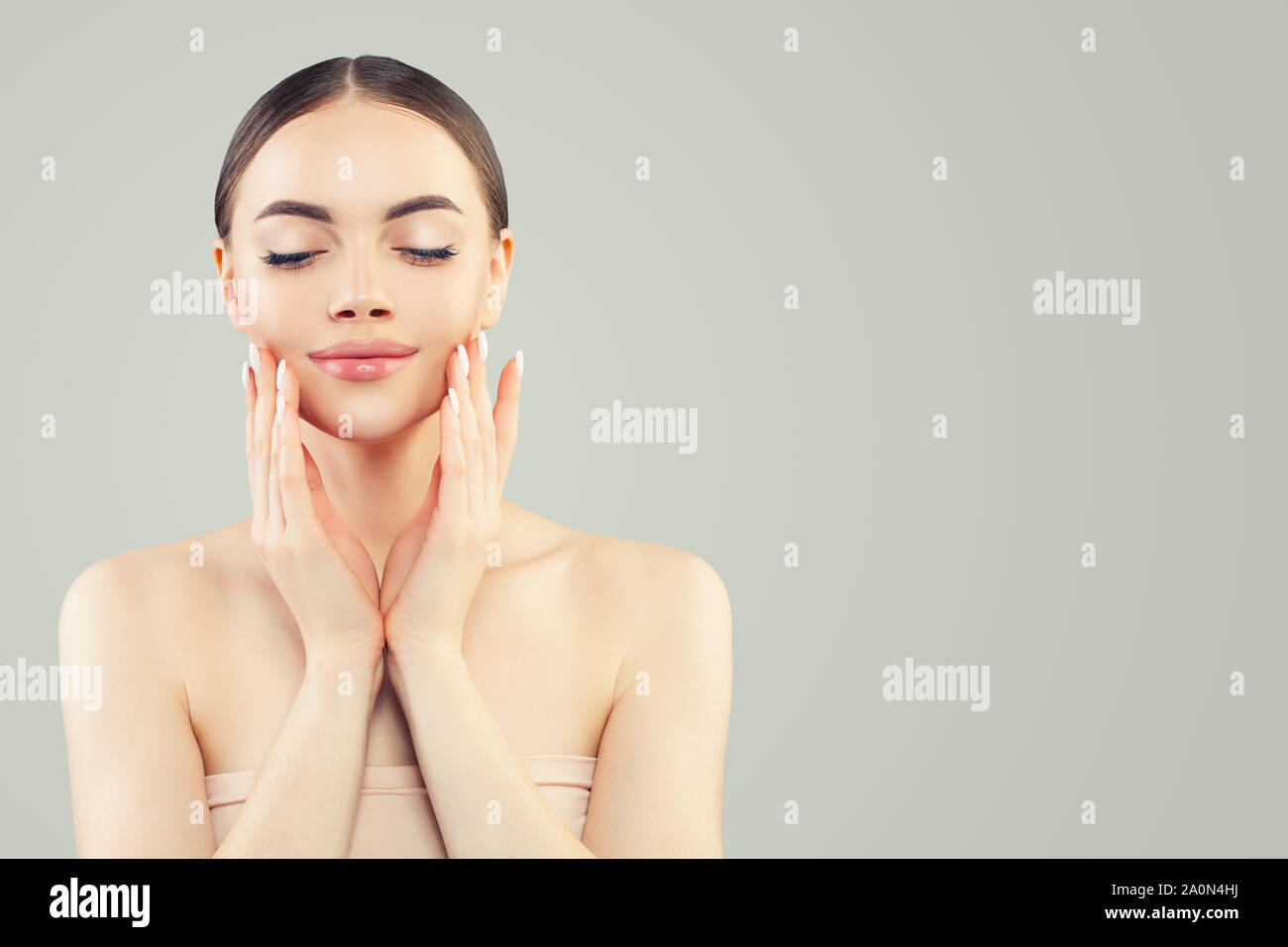 Pretty woman face with clear skin and manicure hands. Skincare ...