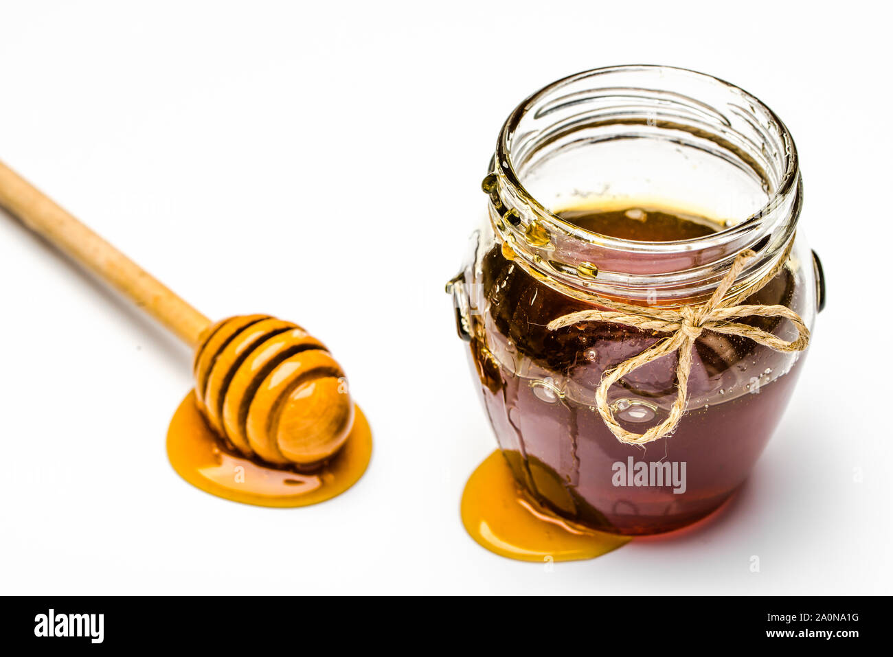 Sticky honey pot and wooden stick of honey on white background Stock ...
