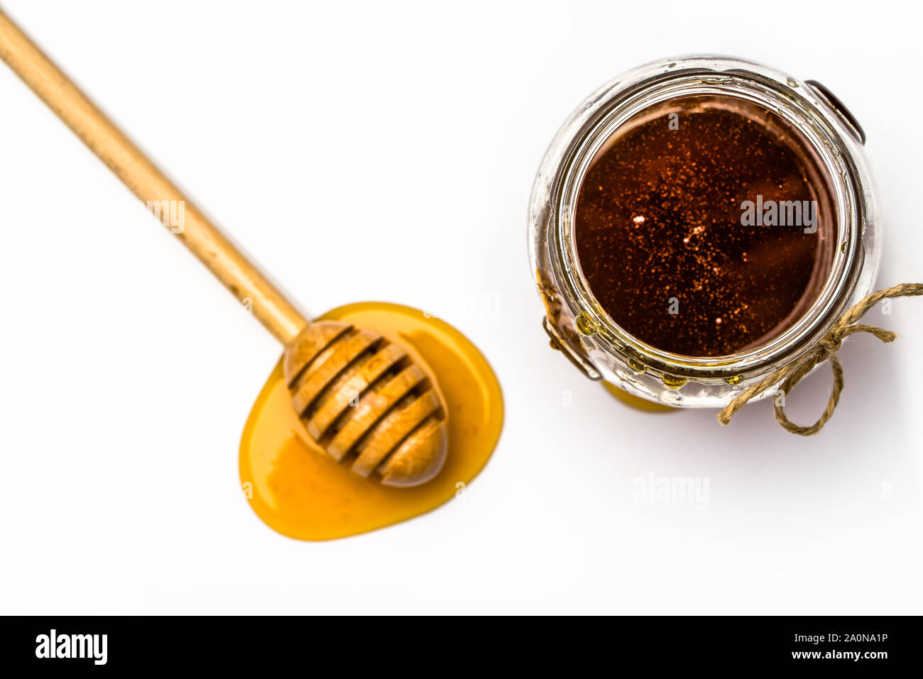 Drop of honey, dipper and glass jar of honey on white background ...