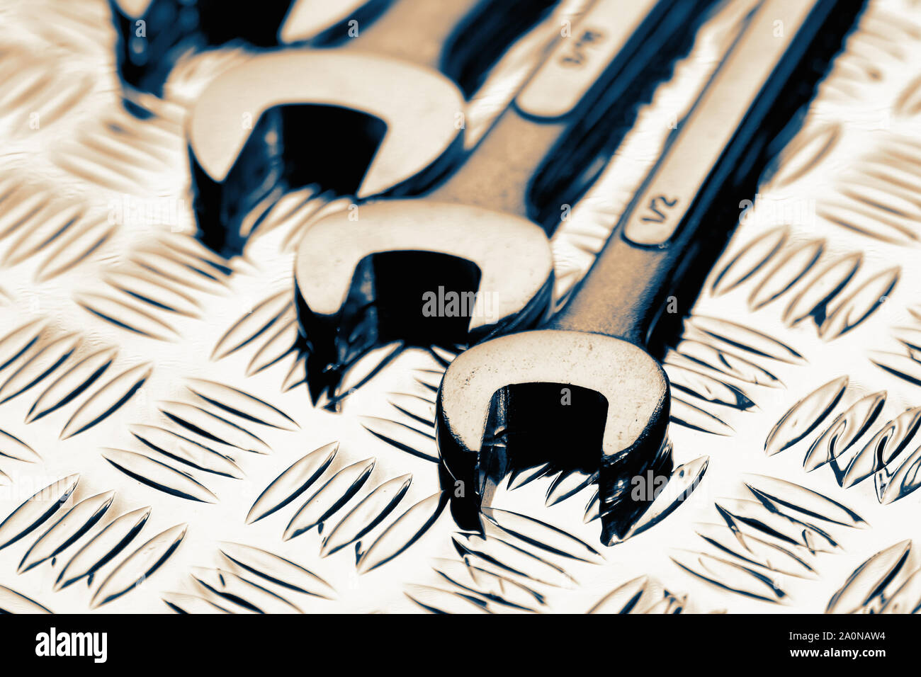 Spanner wrench, various sizes, on a steel checker plate background ...
