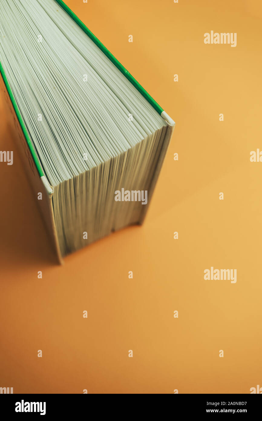 Beautiful new book on a orange background. Top view Stock Photo - Alamy