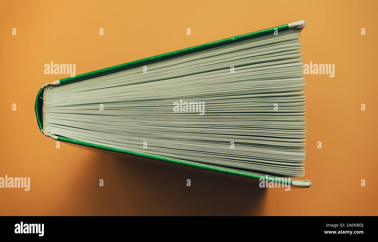 Beautiful new book on a orange background. Top view Stock Photo - Alamy