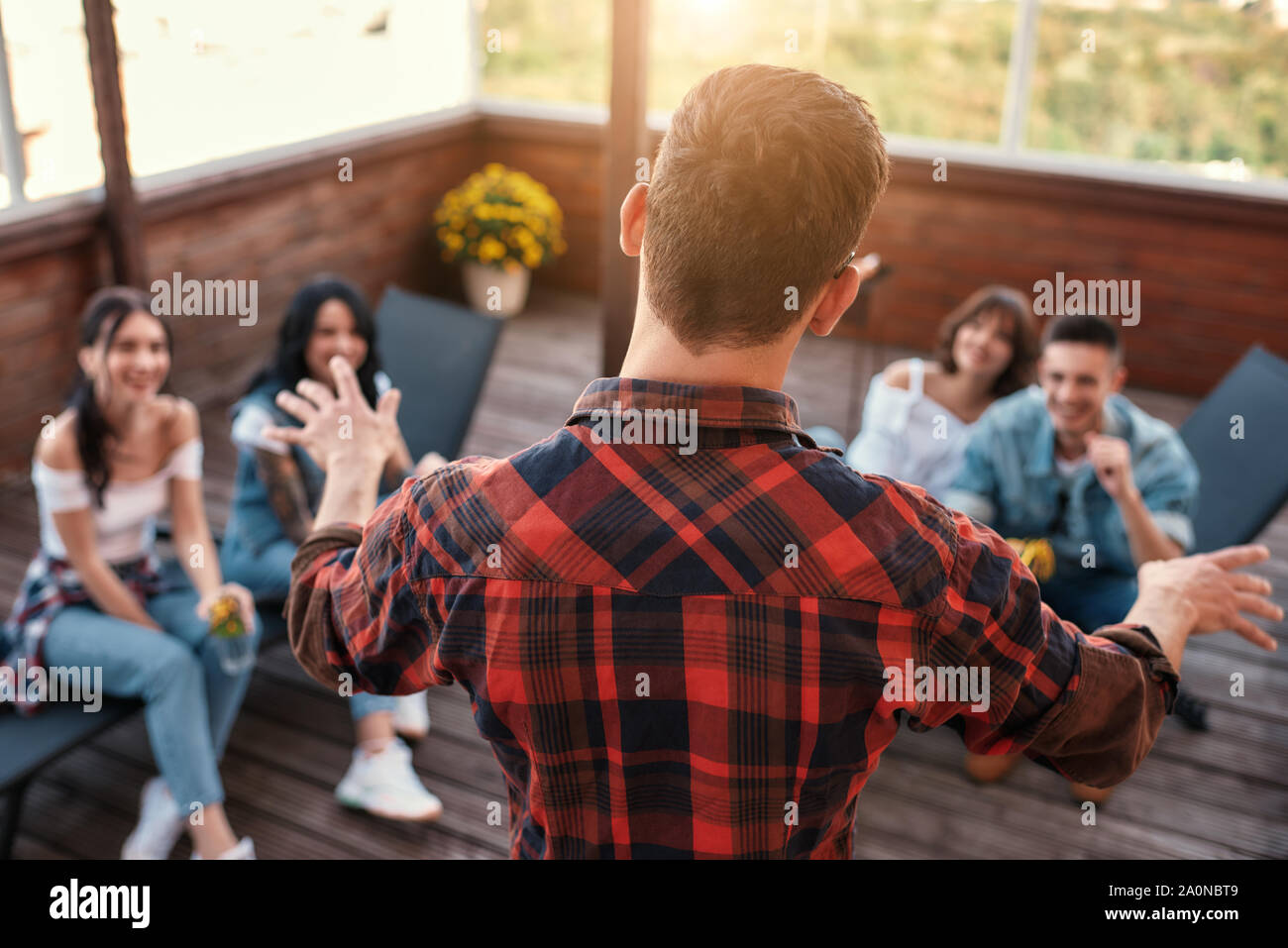 Spending time with best friends. Back view of young man in checkered ...