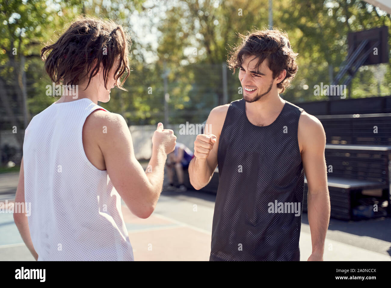 Picture of happy two athletes shaking hands on sports field on summer ...