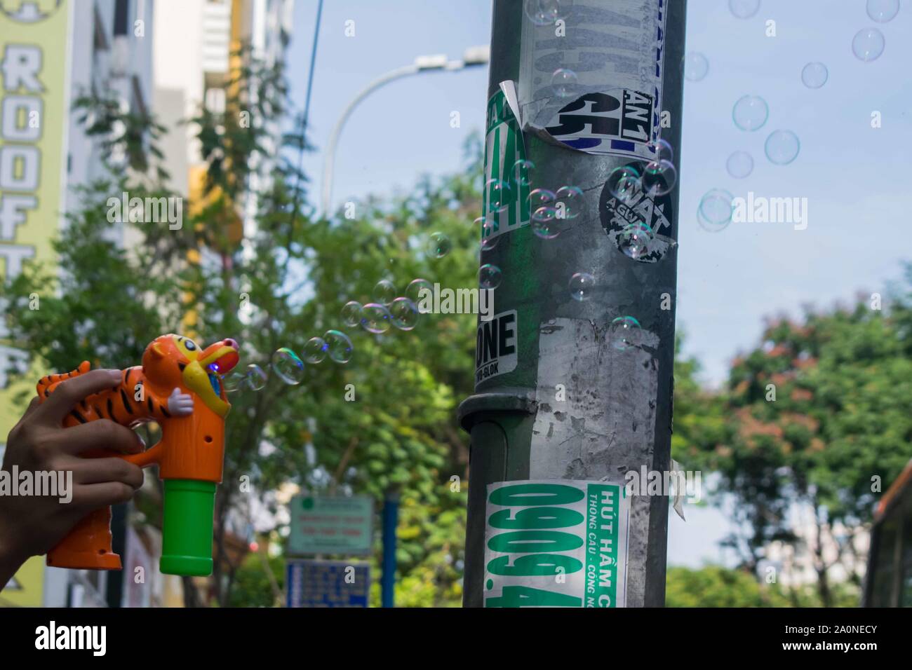 Toy gun. Plastic toy gun makeing lots of air bladders Stock Photo - Alamy