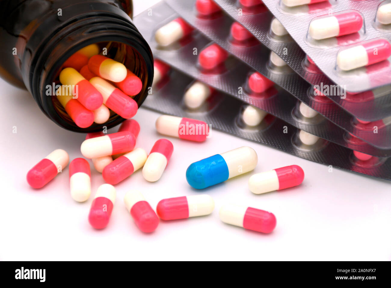 Blue and white capsule in a group of pink and white capsule in ...