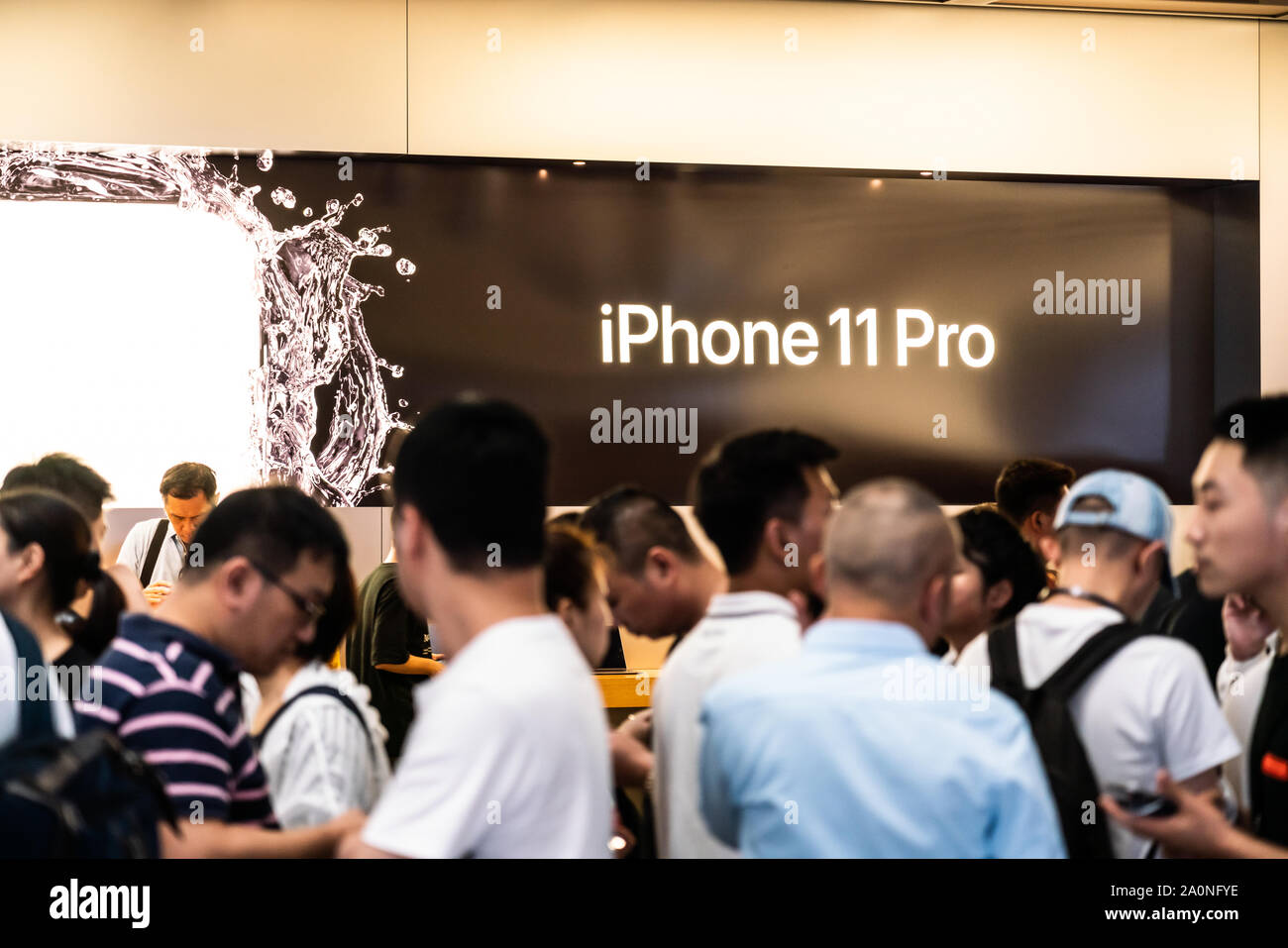 Customers look at the Apple's new iPhone 11 series smartphones at an ...