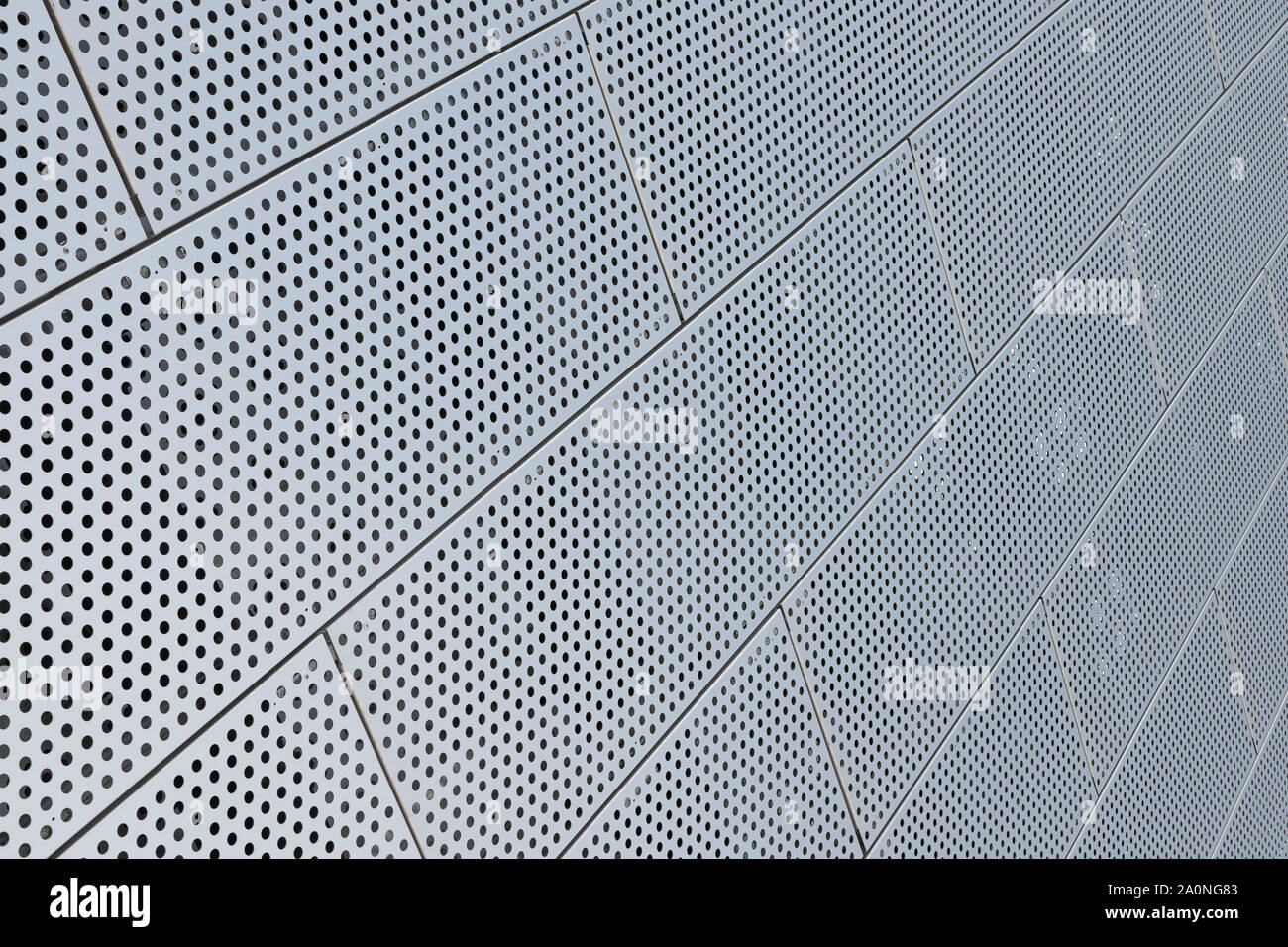 Diagonal view of metal dot pattern pannels on ceiling background Stock ...