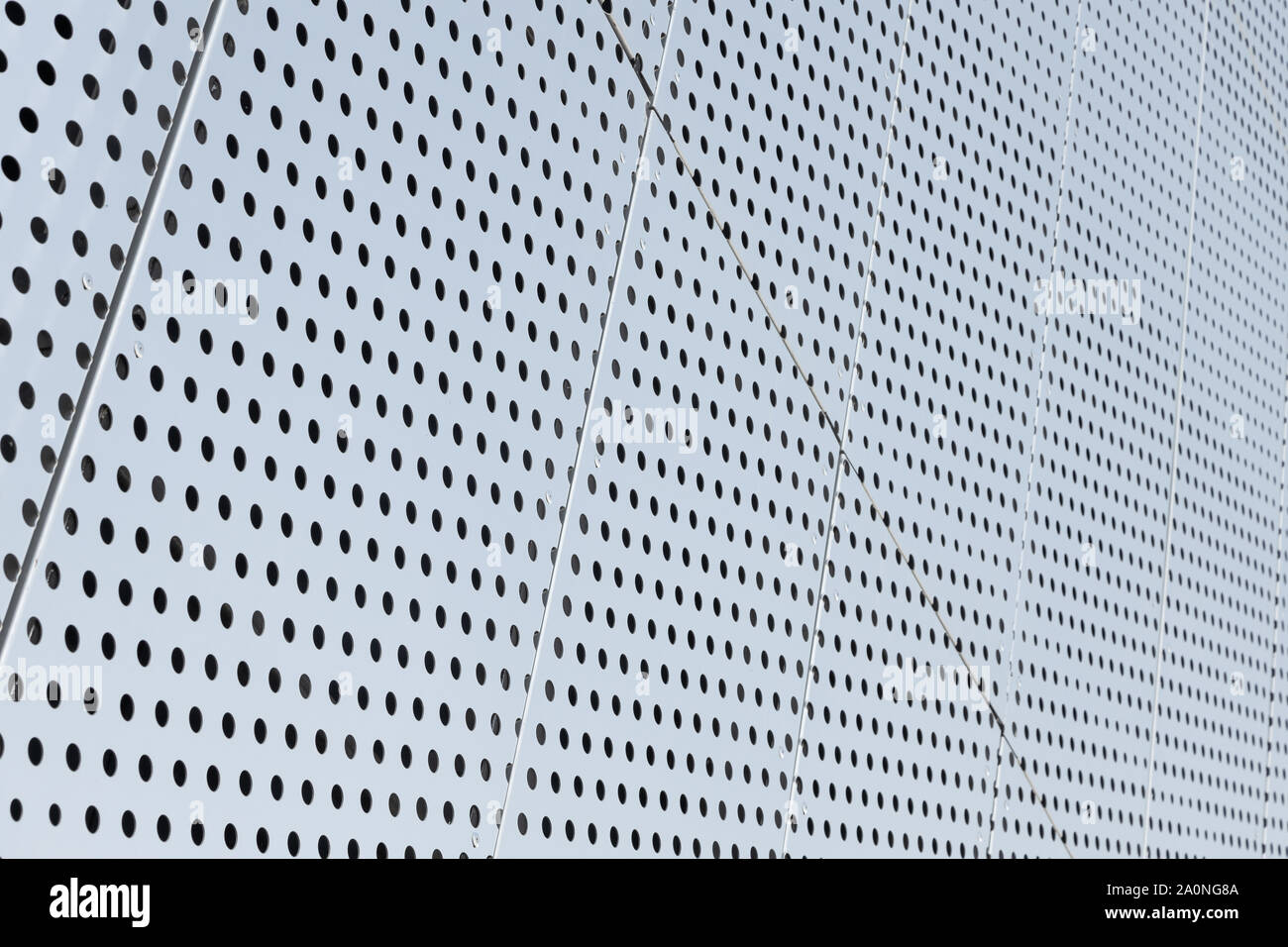 Diagonal view of metall grilles and round holes in metal surface ...