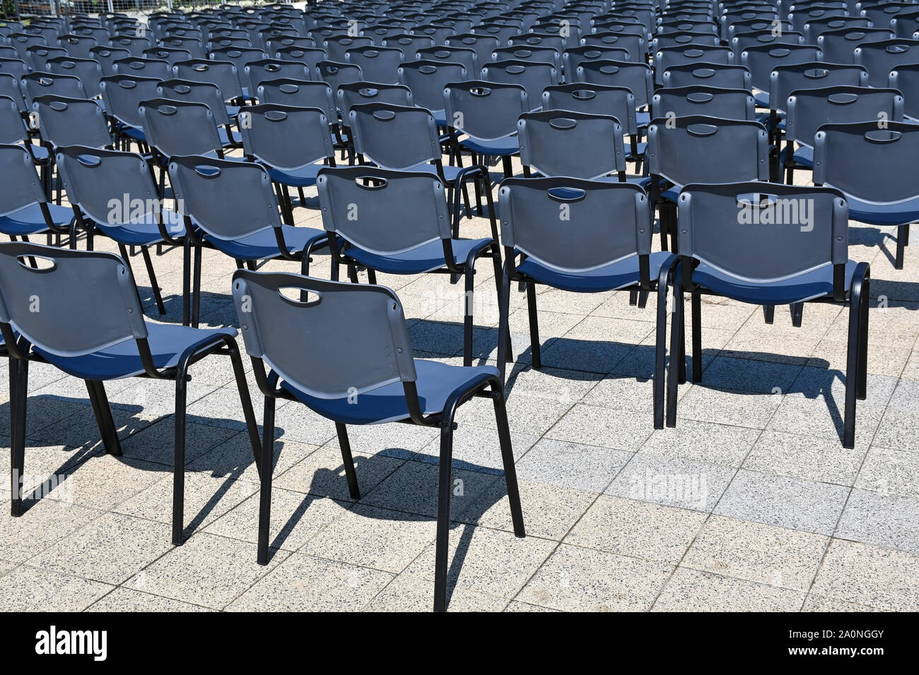 Plastic chairs in a row outdoors Stock Photo - Alamy