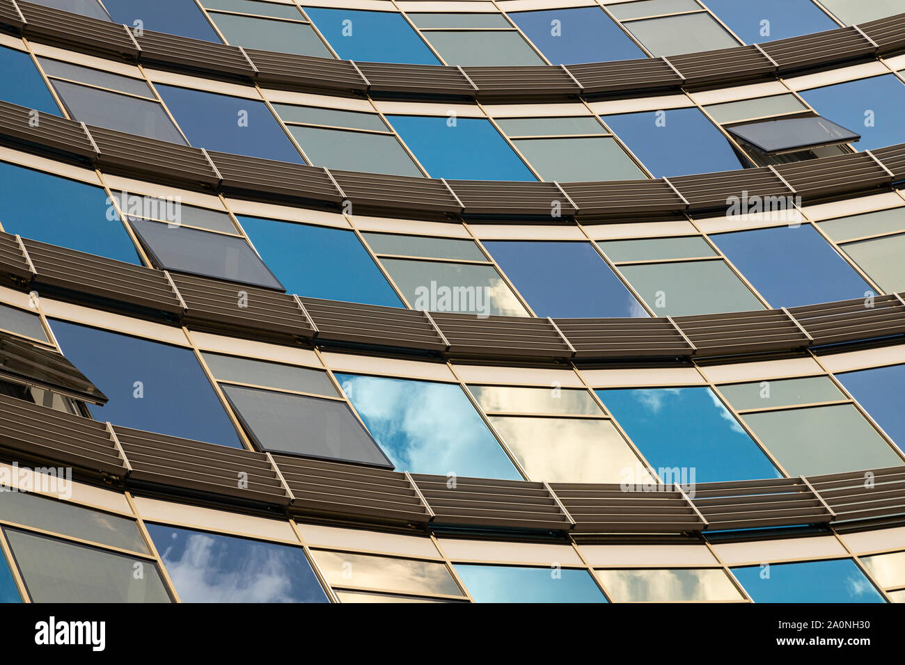 Closeup of glass wall of blue and golden shades with windows Stock ...