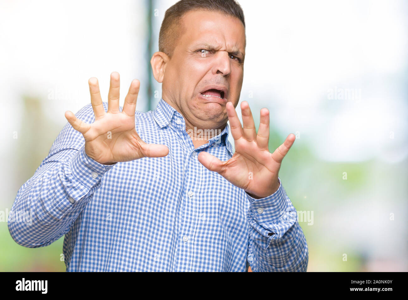 Middle age arab business man over isolated background afraid and ...