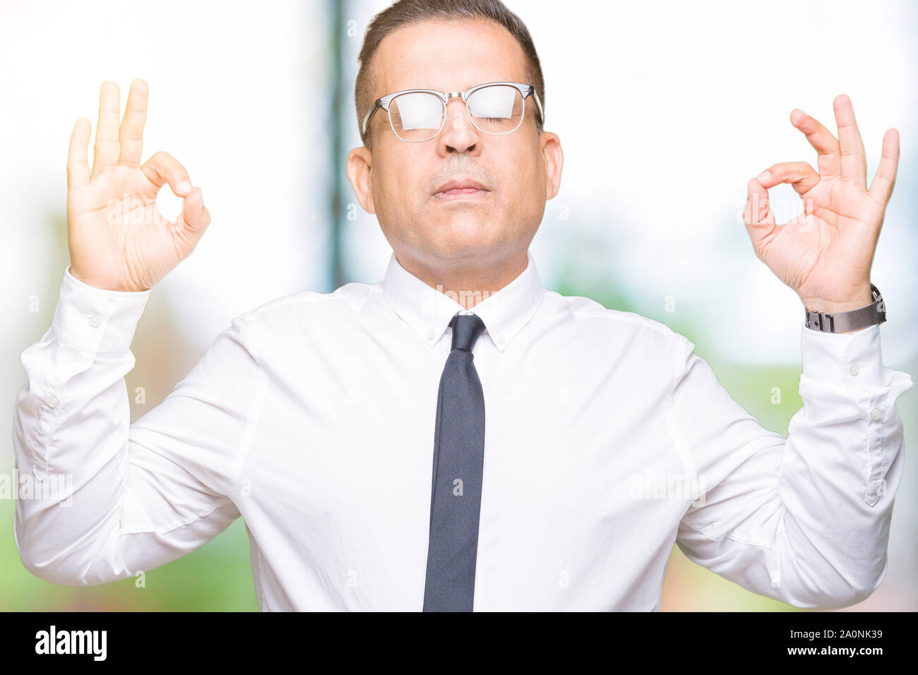 Middle age bussines arab man wearing glasses over isolated background ...