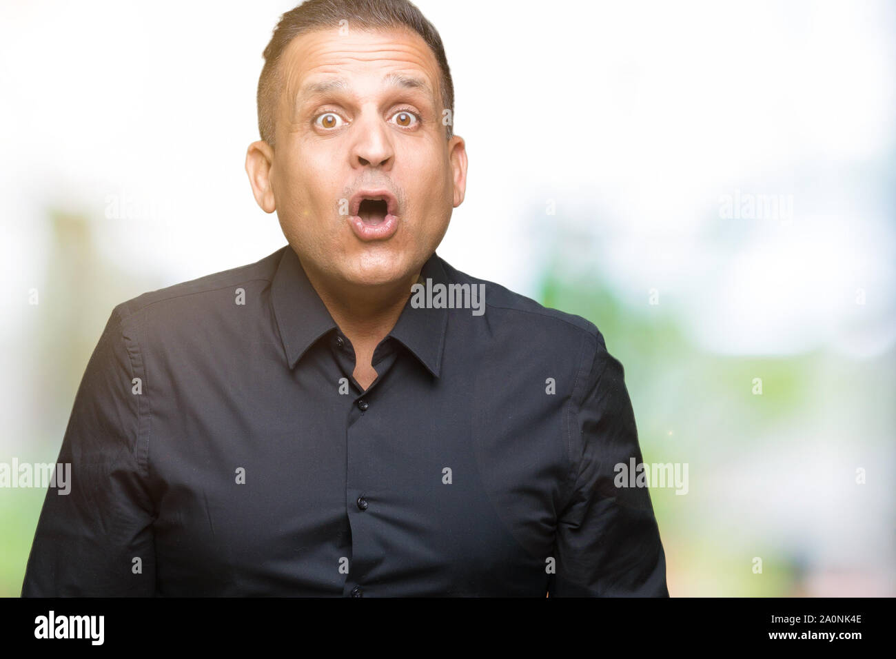 Handsome middle age arab business man over isolated background afraid ...
