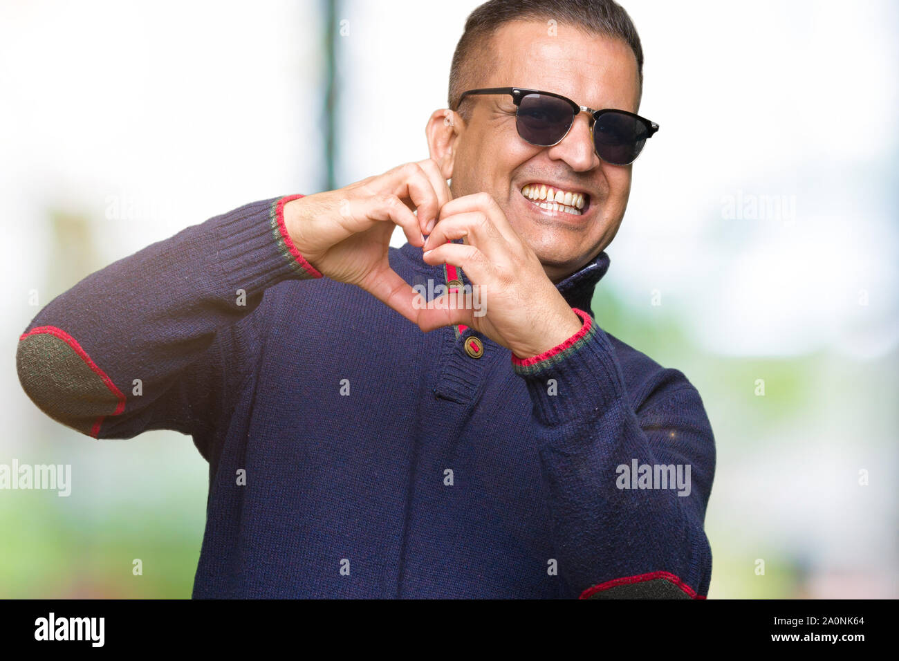 Middle age arab man wearing sunglasses over isolated background smiling ...